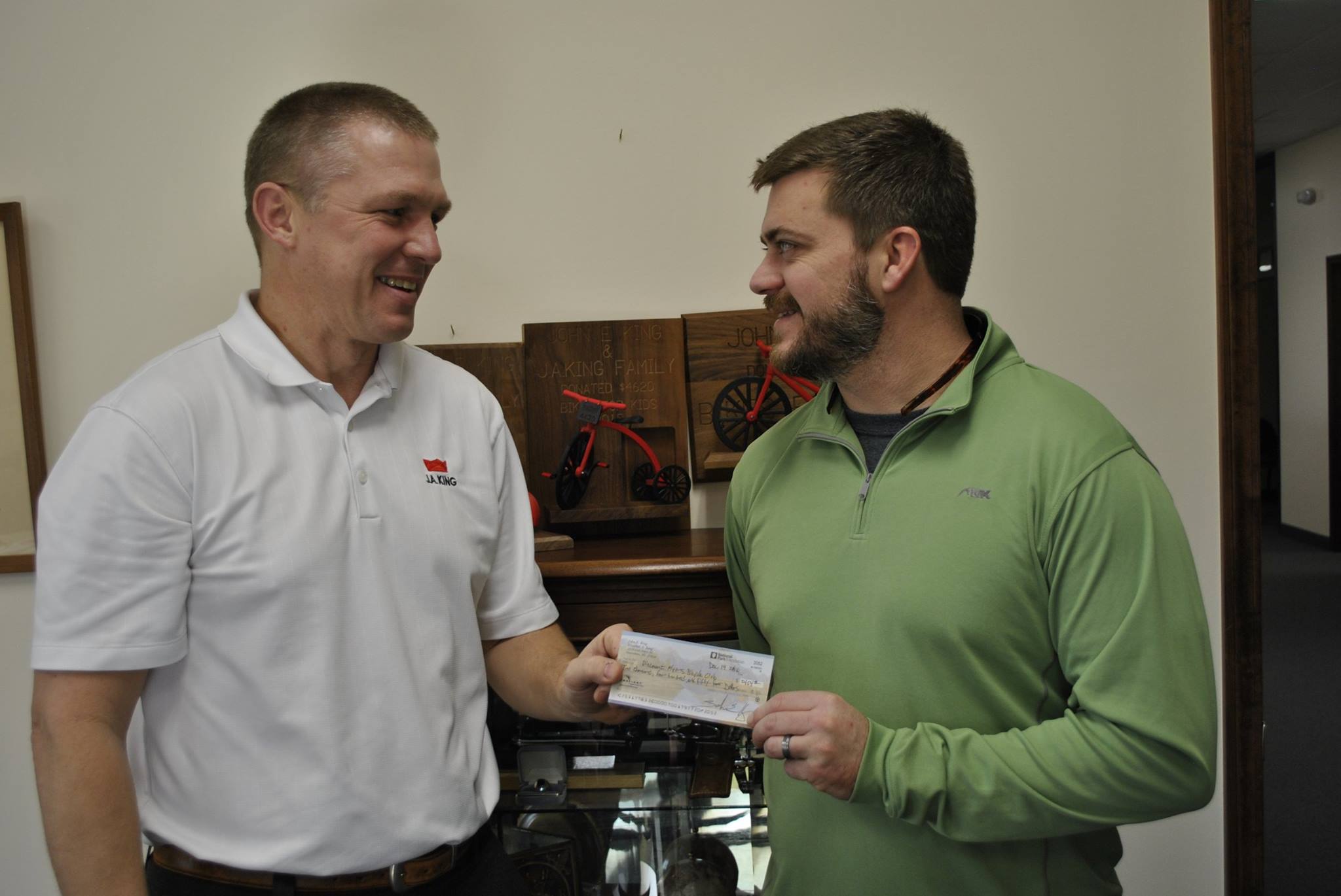J. A. King CEO John King Presents Donation To “Bikes For Kids”